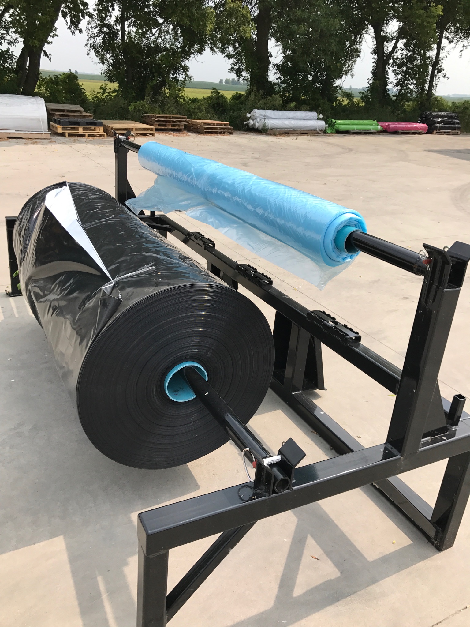 Roll Stand to Assist with Covering Forage Piles