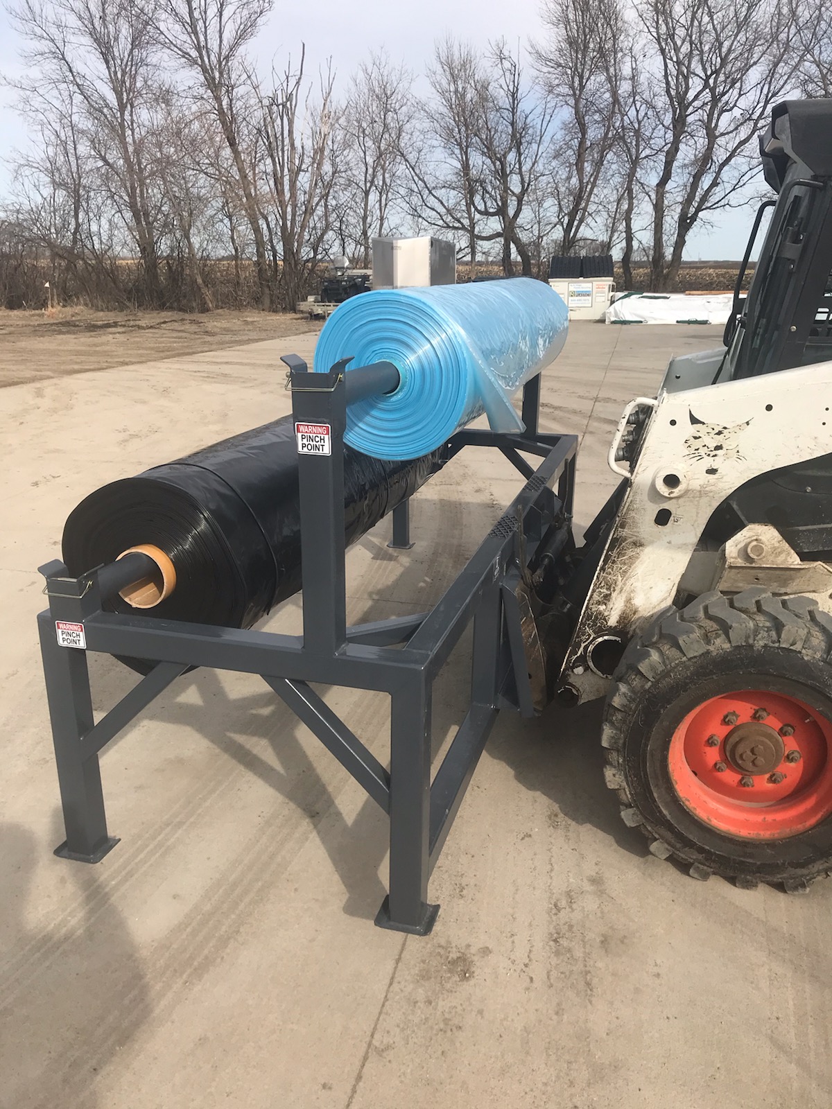 Roll Stand to Assist with Covering Forage Piles
