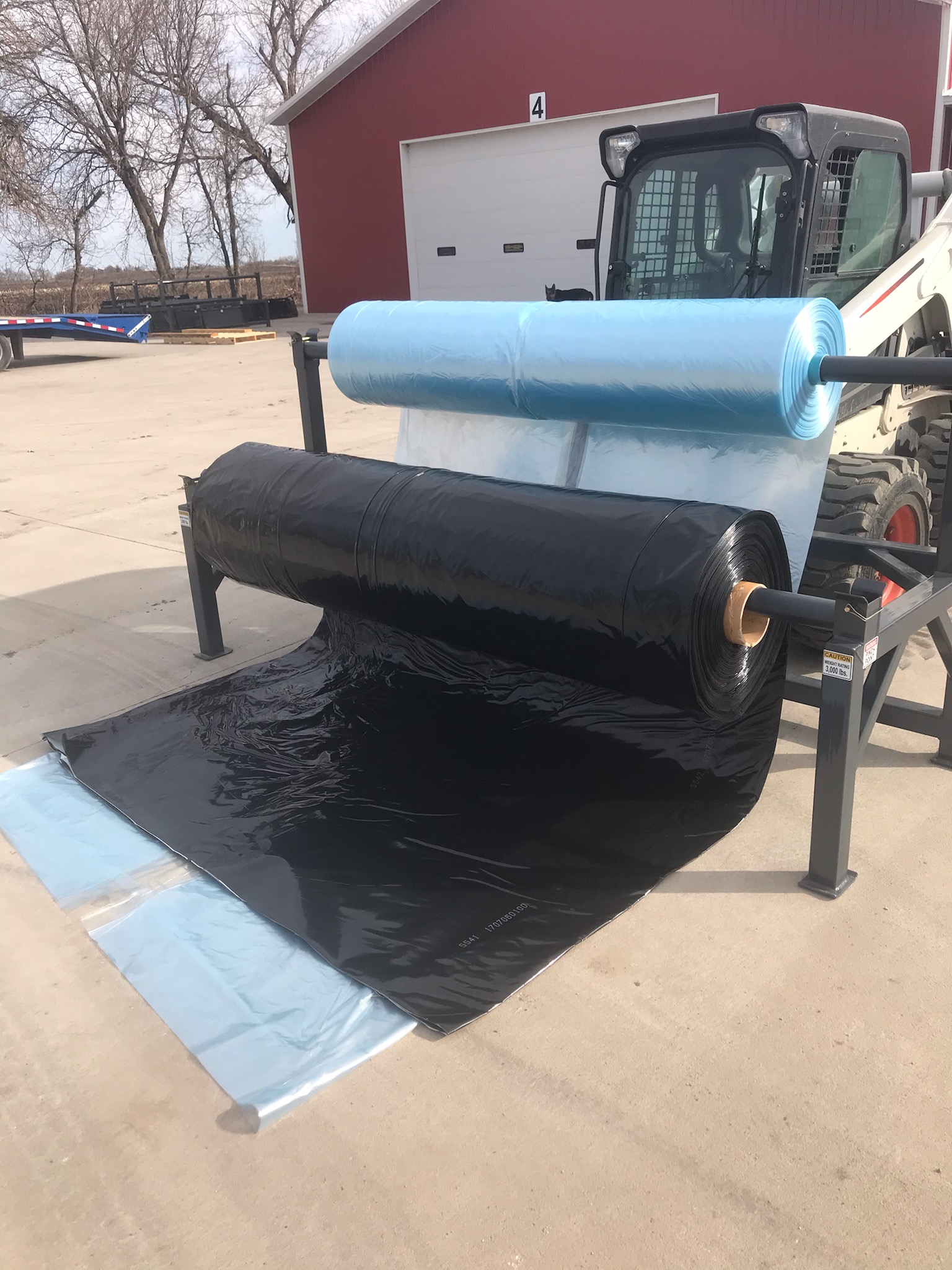Roll Stand to Assist with Covering Forage Piles